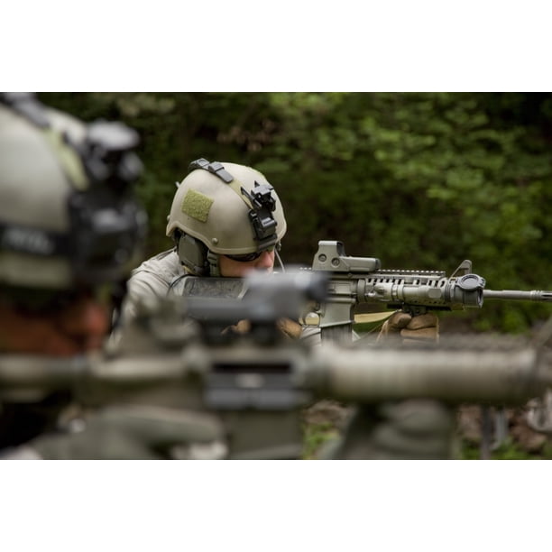 U.S. Special Forces soldiers provide security with automatic rifles ...