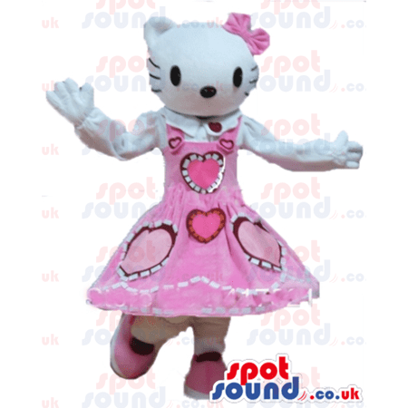 Hello kitty wearing a long sleeveless red dress with pink hearts and a ...