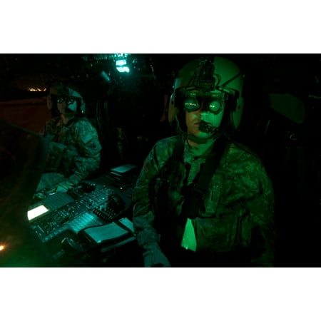 Pilots equipped with night vision goggles in the cockpit of a UH-60 ...