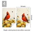 A red bird sitting on top of a bunch of lemonskitchen dish towels4 ...