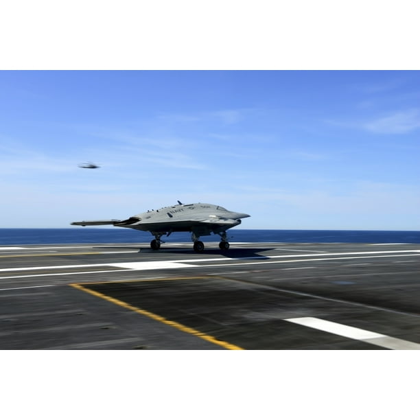 An X-47B unmanned combat air system conducts a touch and go landing ...