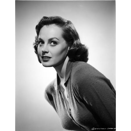 Victoria Shaw leaning into the frame of the camera, wearing a long ...