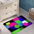 A brightly colored geometric patterned floor mat made of highly ...