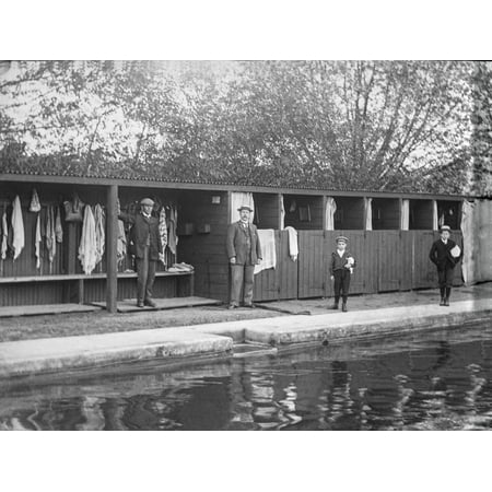 Outdoor swimming pool in the Victorian era with two boys waiting to go ...