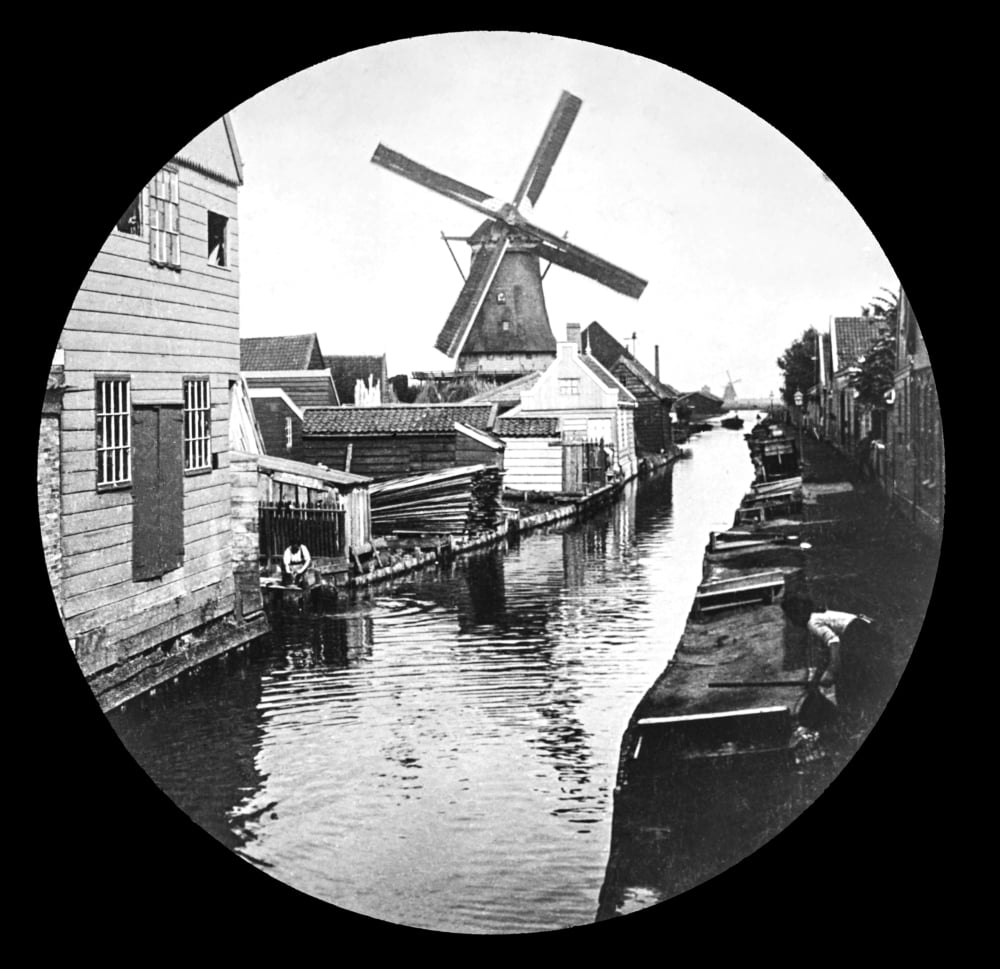Magic lantern slide circa 1900.Victorian. A windmill on the river with ...