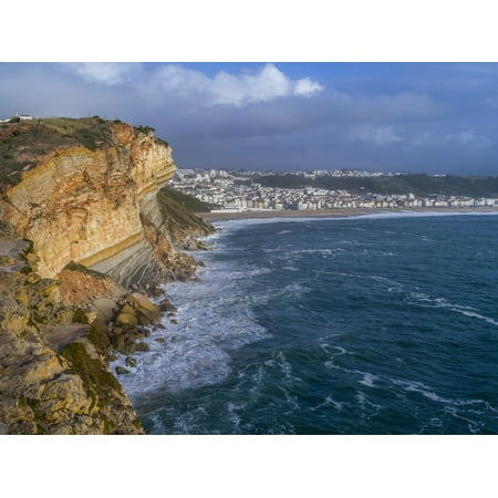 Rugged cliffs and beach along the coastline of Nazare, Portugal, the ...