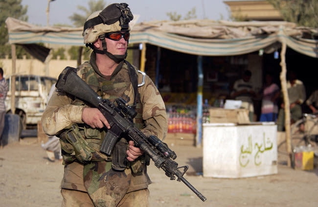 US Army Specialist securing an area during a routine patrol in ...