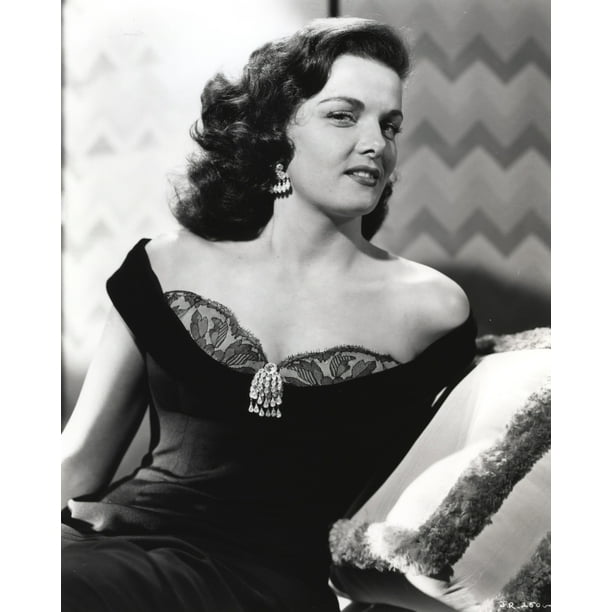 Jane Russell Seated on a Couch in Black Lace Top Shoulder Dress with ...