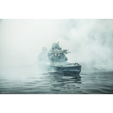 Special forces operator armed with machine gun, paddling Army kayak ...