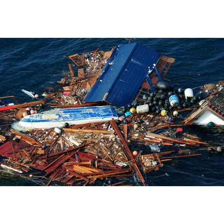 An Overturned Tug Boat Floats In The Debris In Left By The March 11 ...