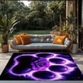 A diatomaceous earth bathroom mat with a purple paw print rose print ...