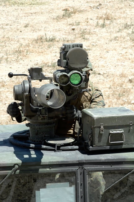 A US Marine looks though the optics of a BGM-71 TOW anti-tank guided ...