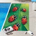 1 beach towel with red ladybug print on green leaves, natural insect ...