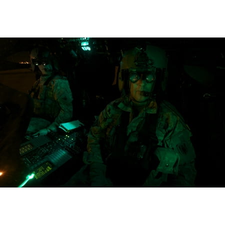 Pilots equipped with night vision goggles in the cockpit of a UH-60 ...