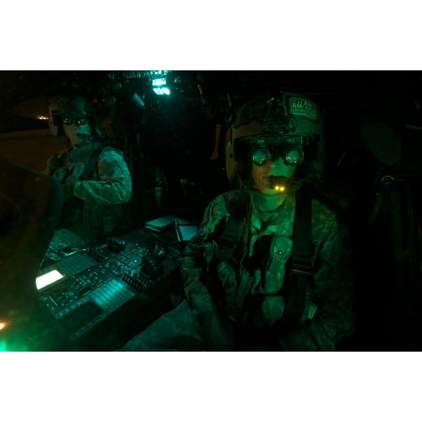 Pilots equipped with night vision goggles in the cockpit of a UH-60 ...