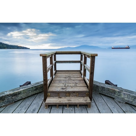 A wooden viewing platform at the end of a dock looks out to a ship on ...