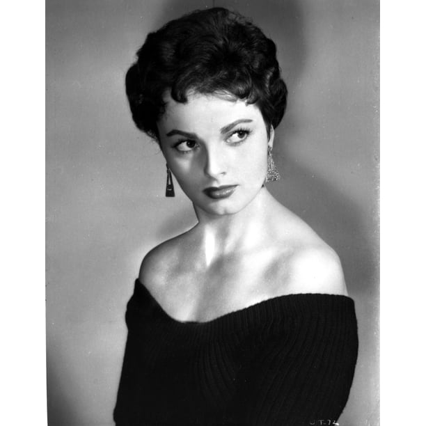 Ursula Theiss wearing a completely off the shoulder top, leering away ...