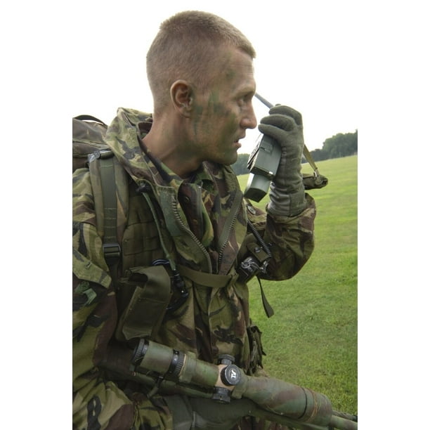 A member of the British Army Pathfinder Platoon radios in his location ...
