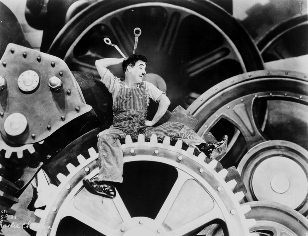 A film still of Charlie Chaplin inside a machine from Modern Times ...
