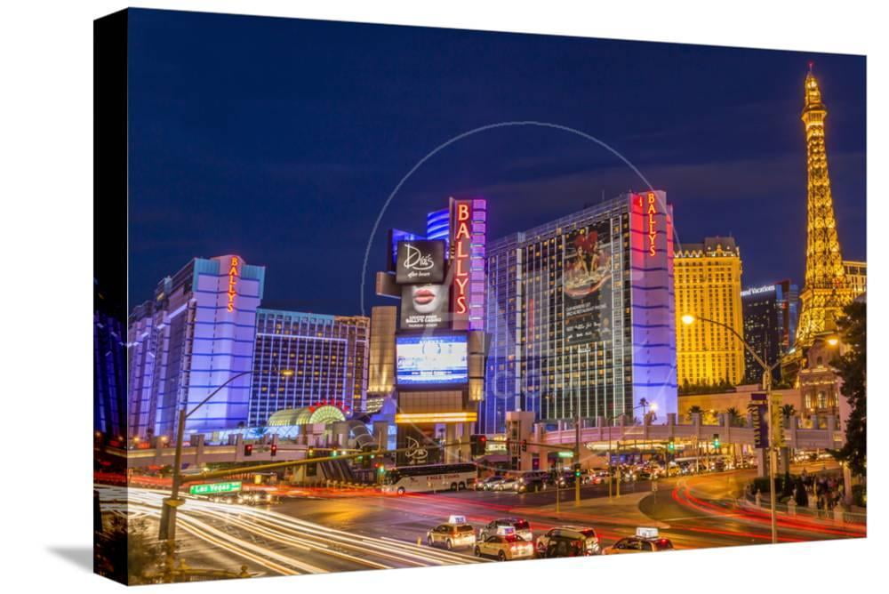 Neon Lights on Las Vegas Strip at Dusk with Car Headlights Leaving ...