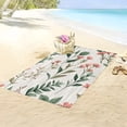 A soft microfiber beach towel with a stylish design featuring pink ...