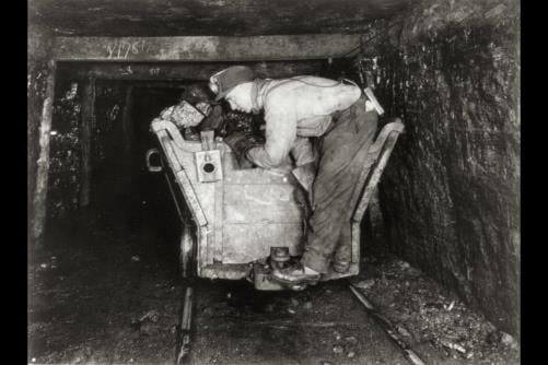 8x12 Photo: Coal mining scenes,man standing on back of coal car in ...