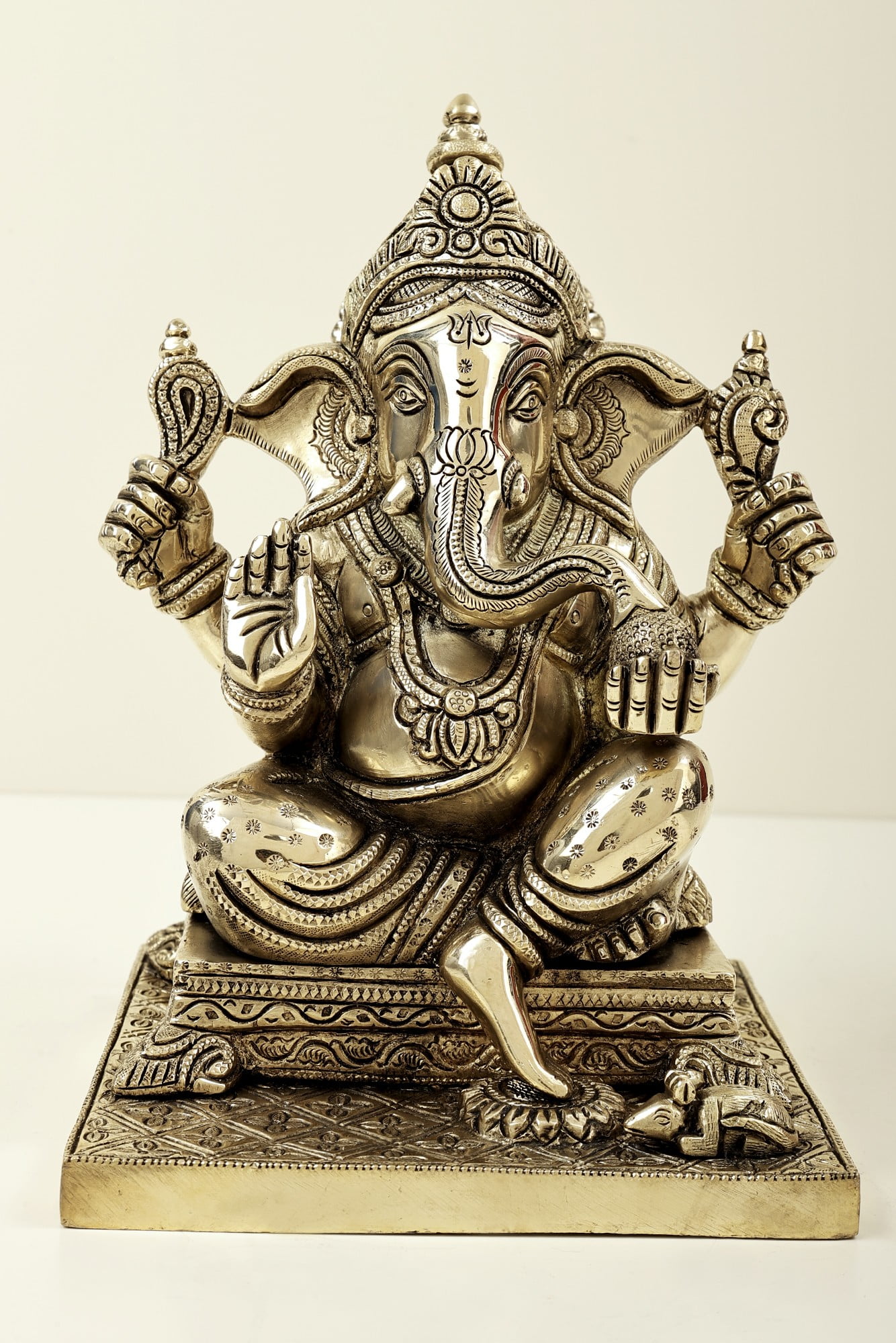 9" Lord Ganesha Seated on Pedestal and Eating Modak | Brass Bhagawan ...