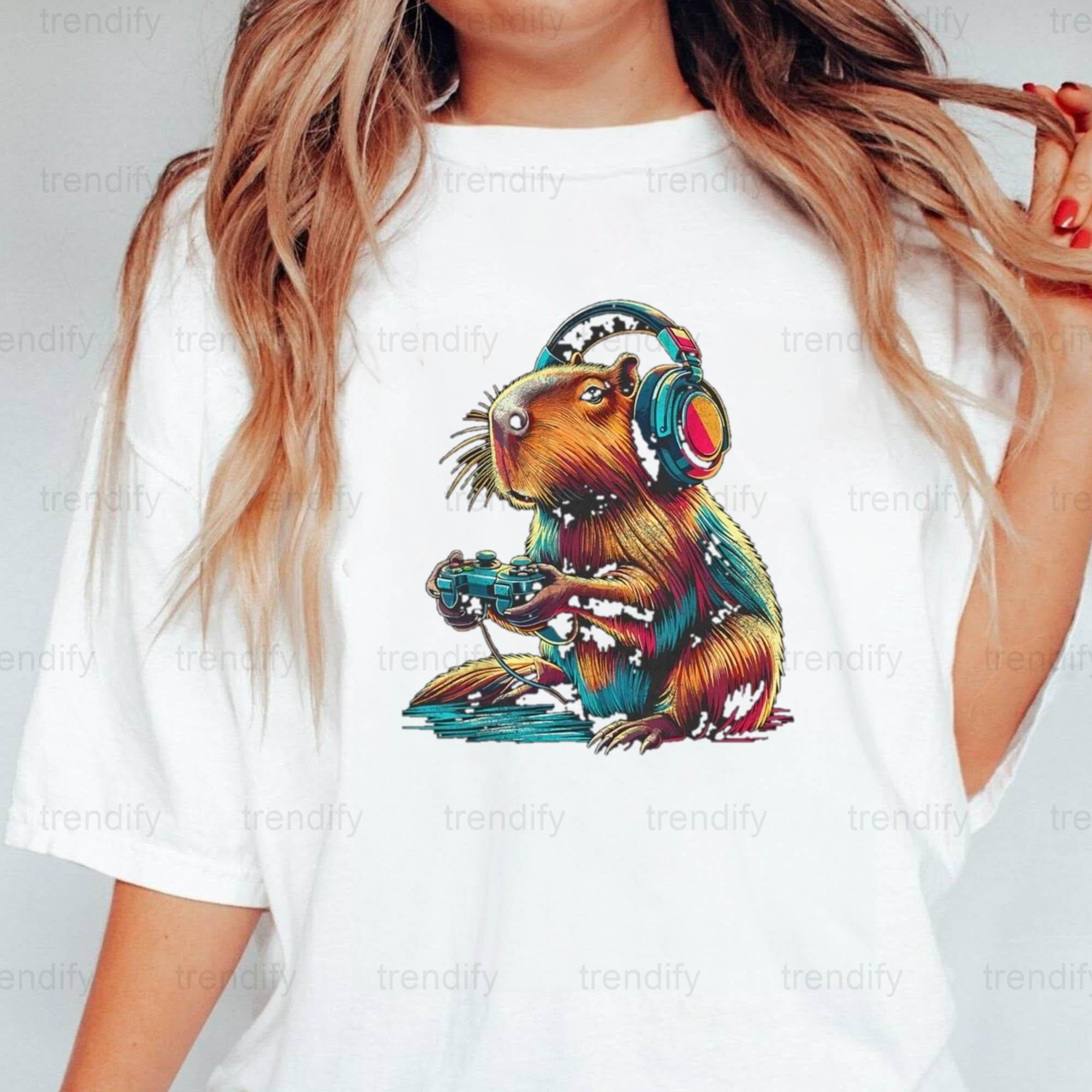 A Funny Capybara Playing Video Games and Eating Pizza Graphic Art ... A Funny Capybara Playing Video Games and Eating Pizza Graphic Art ...