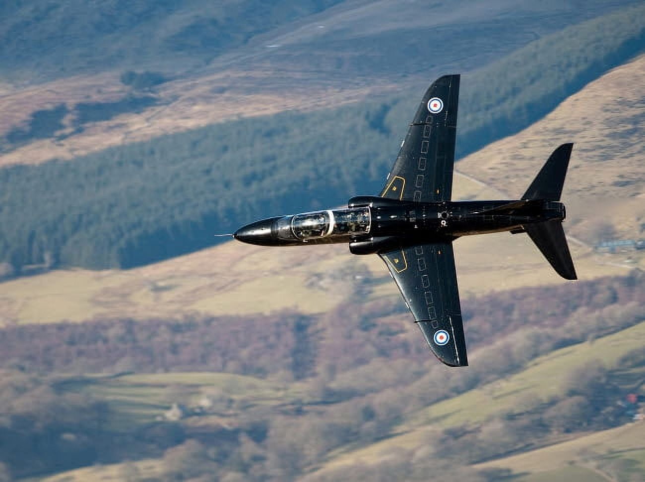 A Hawk T1 trainer aircraft of the Royal Air Force low flying over North ...