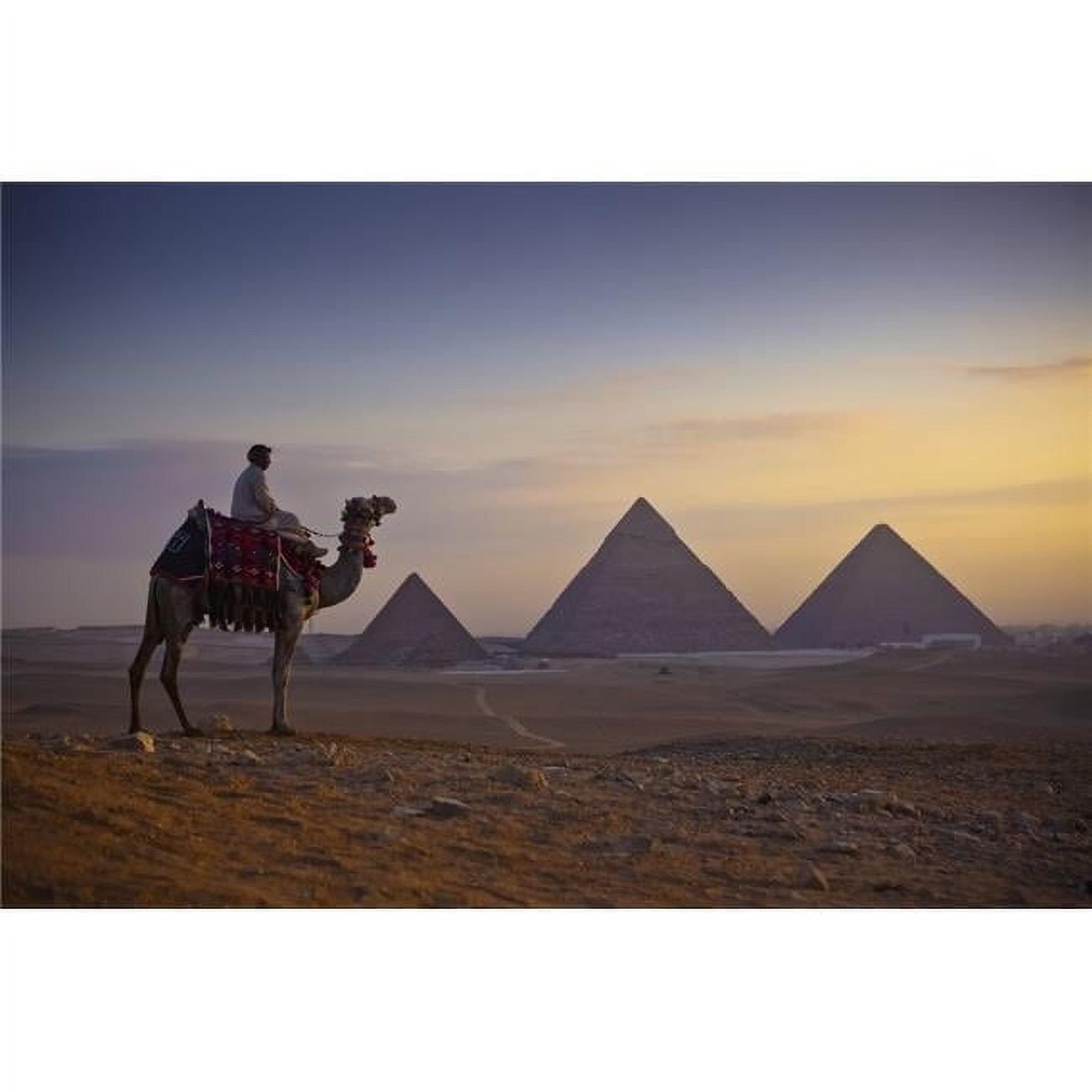 A Lone Camel & Rider Stand in Front of The Setting Sun with The Great ...