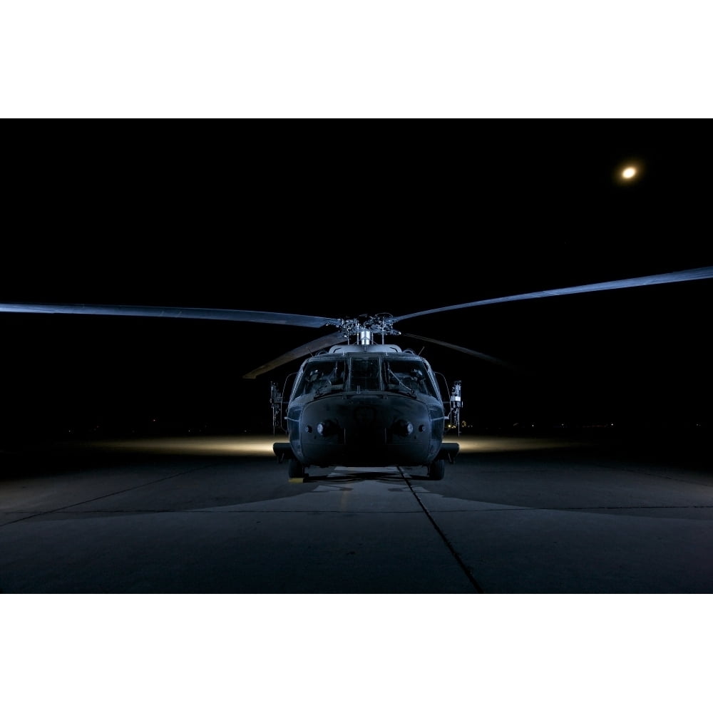 A UH-60 Black Hawk helicopter lit up by multiple external flash units ...