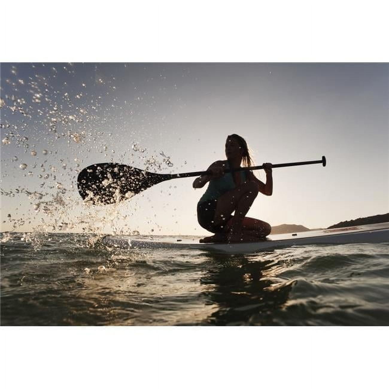 A Woman Paddling While On Her Knees On A Surf Board Off Dos Mares Beach ...