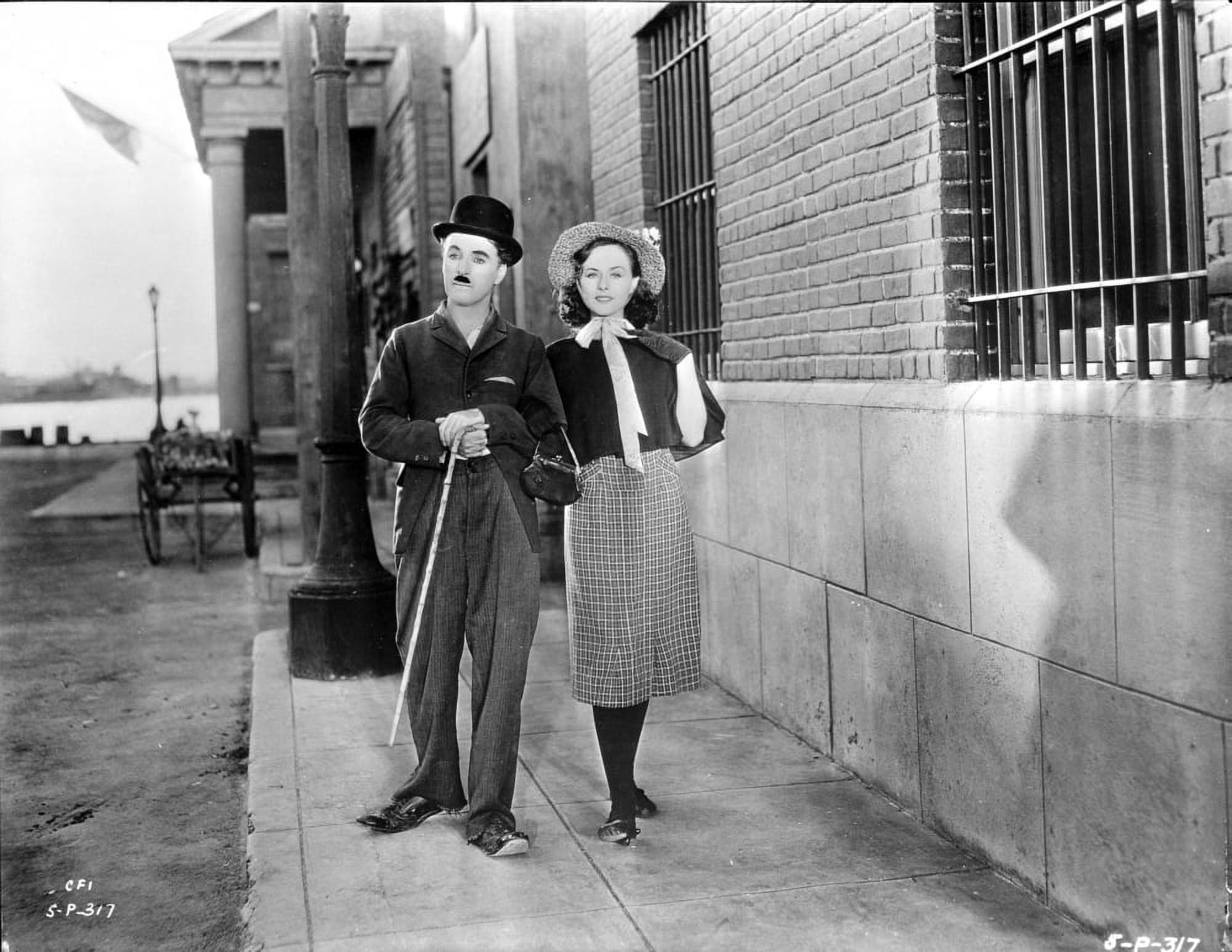 A film still of Charlie Chaplin walking with a co star Photo Print (8 x ...