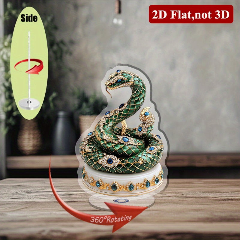 A rotating acrylic display featuring a green and gold snake embellished ...