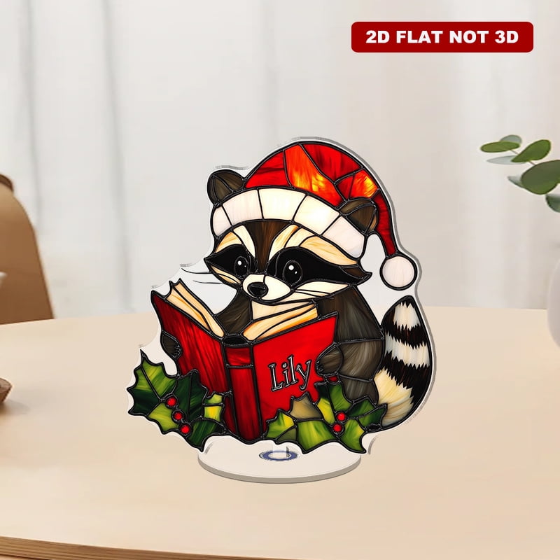 A rotating acrylic display featuring a stained glass raccoon in a Santa ...