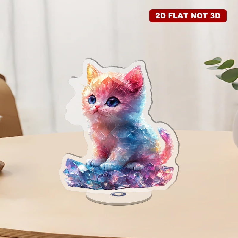A rotating acrylic display piece featuring a colorful crystal kitten squatting on a vibrant ...