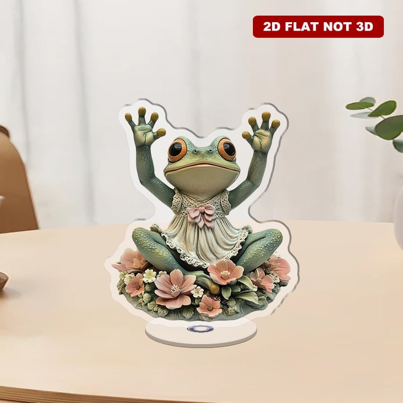 A rotating acrylic figurine of a joyful frog in a frilly dress ...