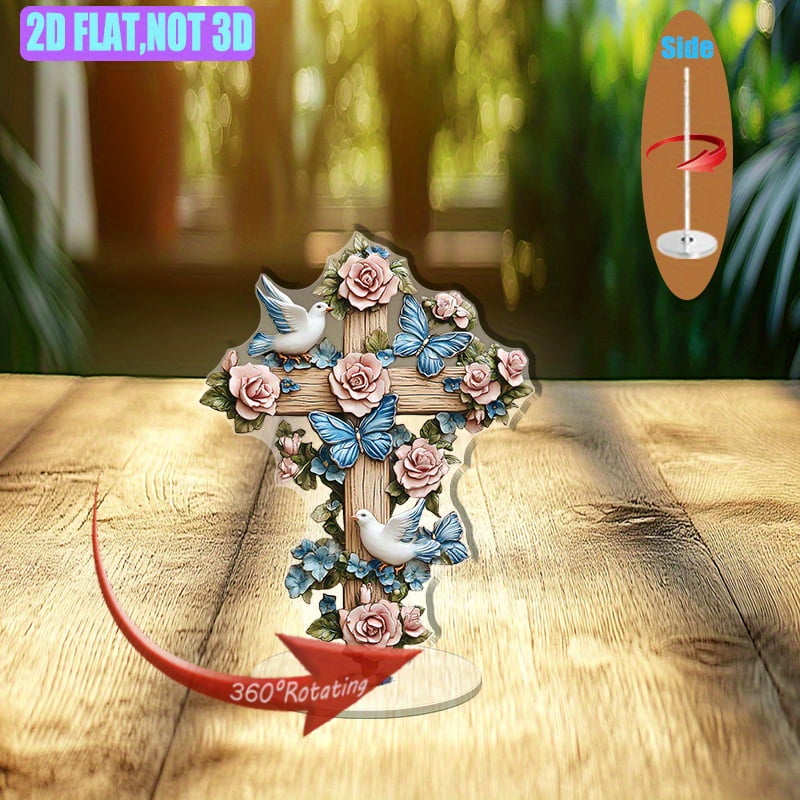 A rotating acrylic ornament featuring a wooden cross decorated with roses blue butterflies and ...
