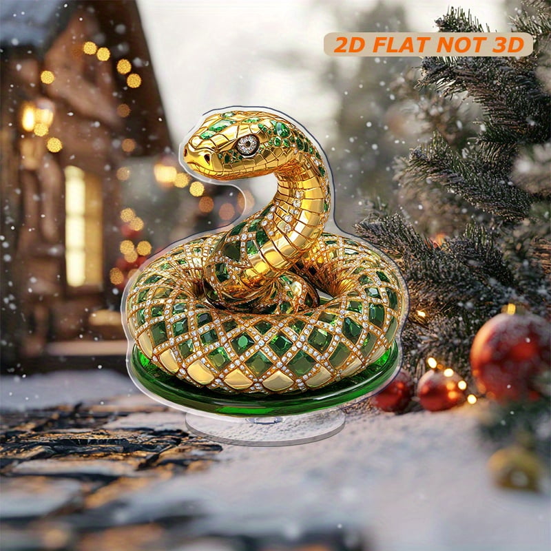 A rotating acrylic sculpture of a golden snake with emerald scales and ...
