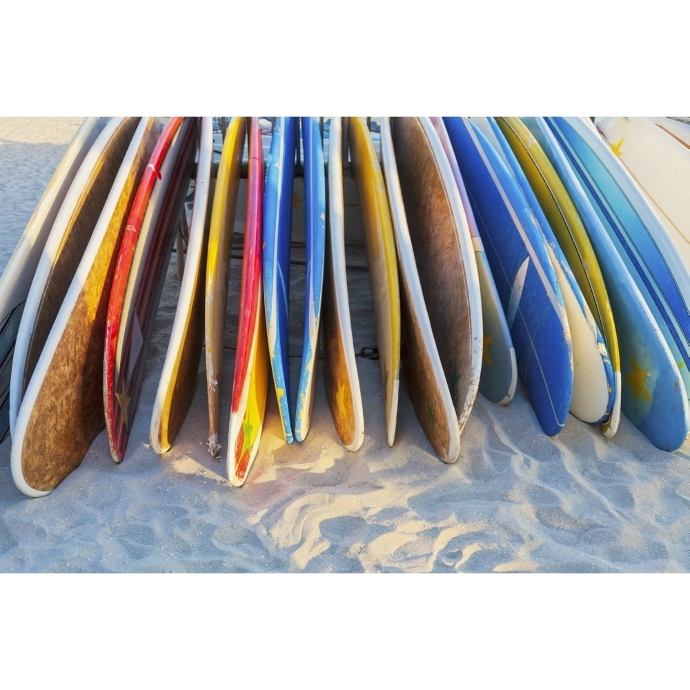 A stack of colourful longboard surfboards placed on the beach,; Waikiki ...