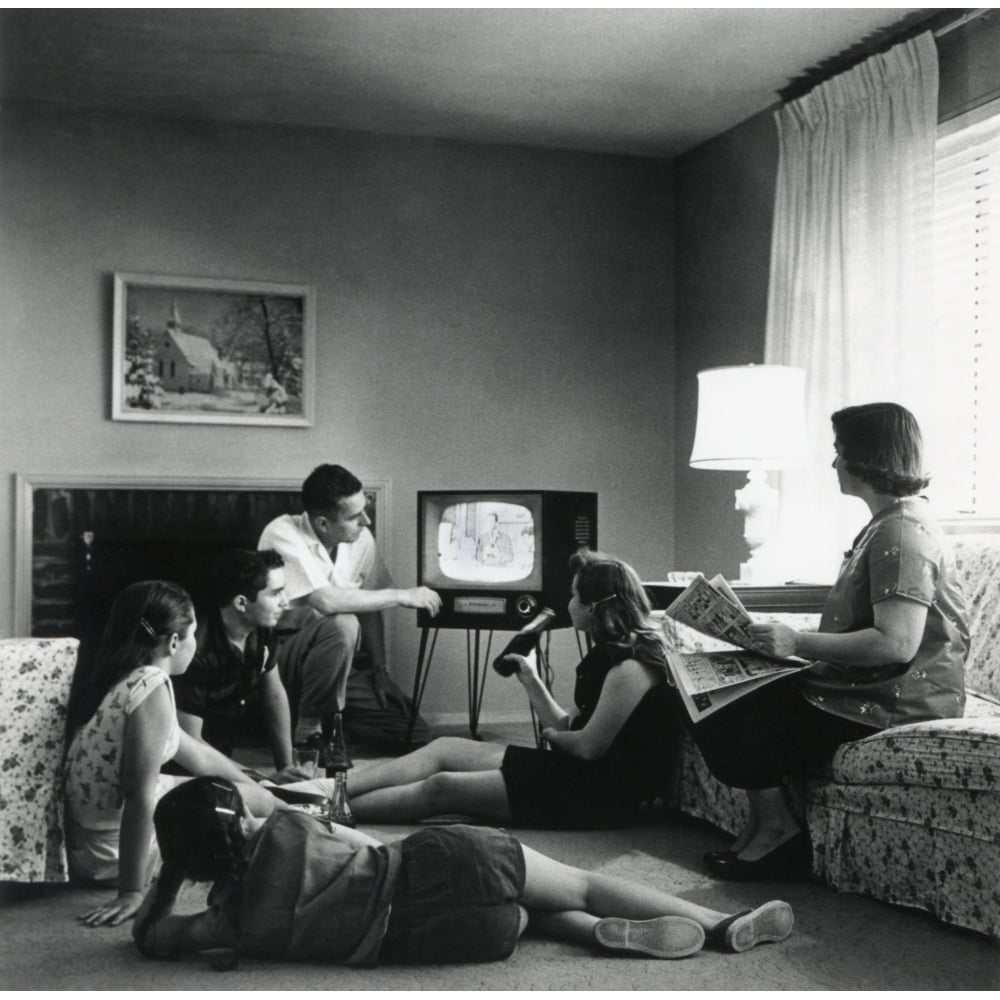 American Family Watching Television In The Living Room Of Their Home ...