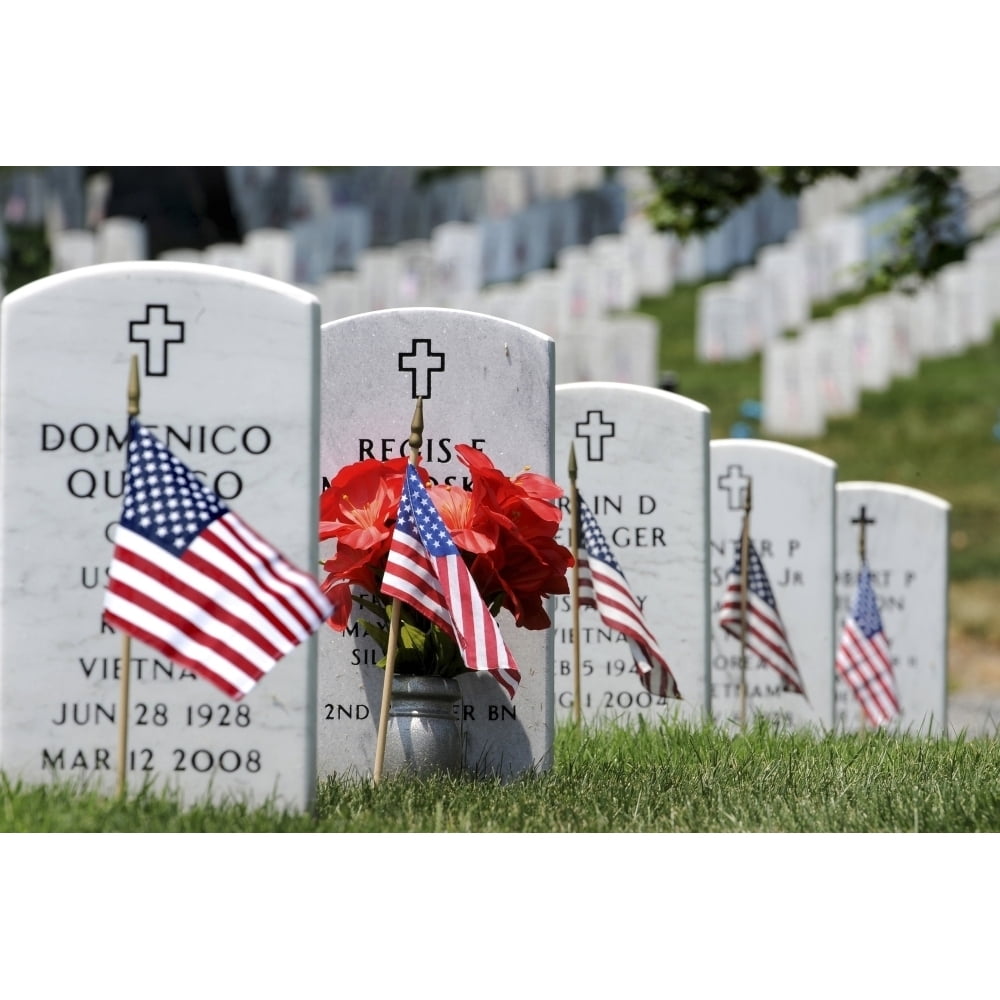 American flags placed in the front of headstones at Arlington National ...