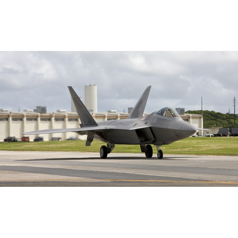 An F-22 Raptor taxis to the end of runway at Kadena Air Base Japan ...