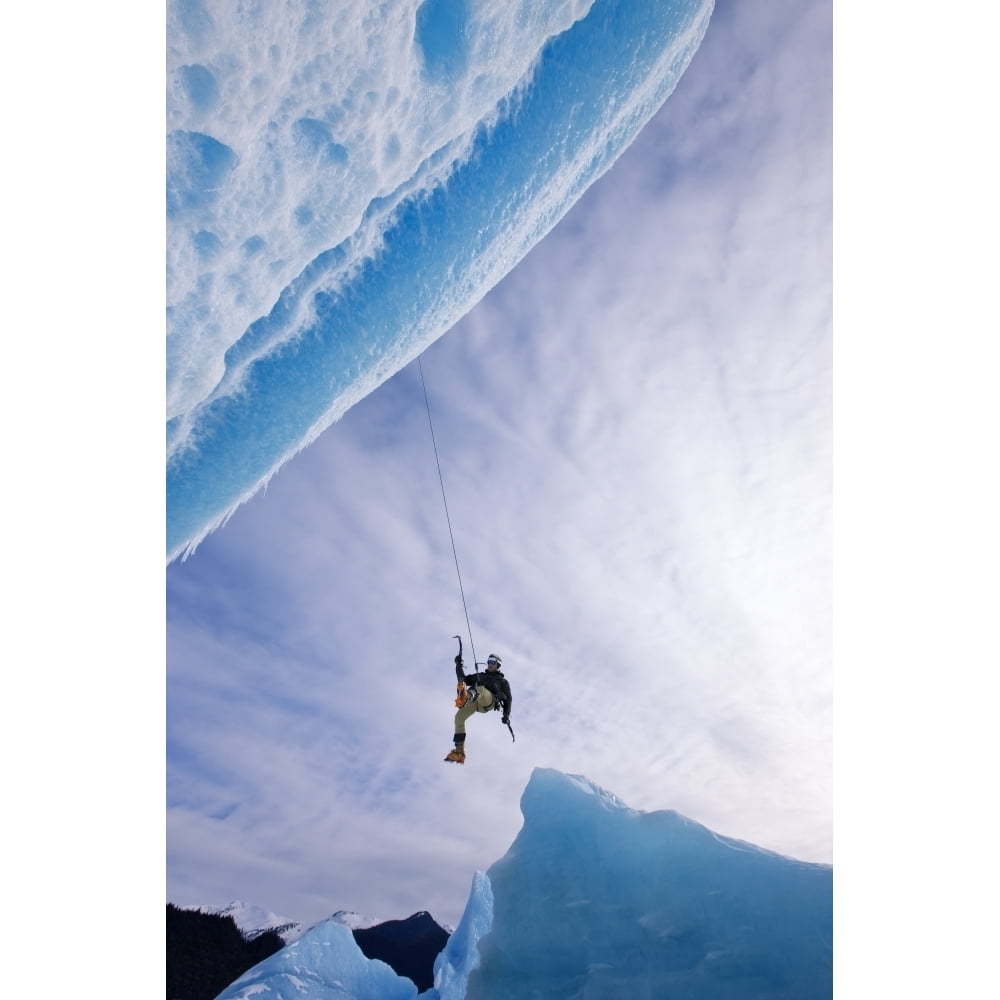 An Ice Climber Swings Down From Rope To Reach Face Of A Large Iceberg ...