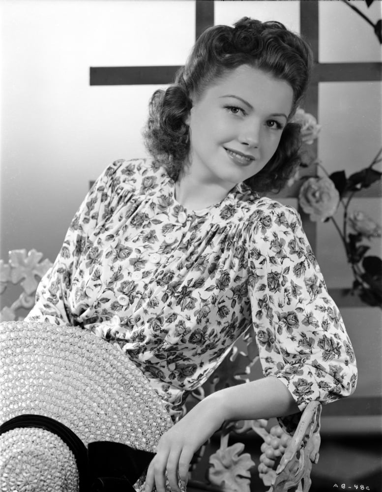 Anne Baxter posed on Floral Dress sitting and smiling Photo Print (8 x ...