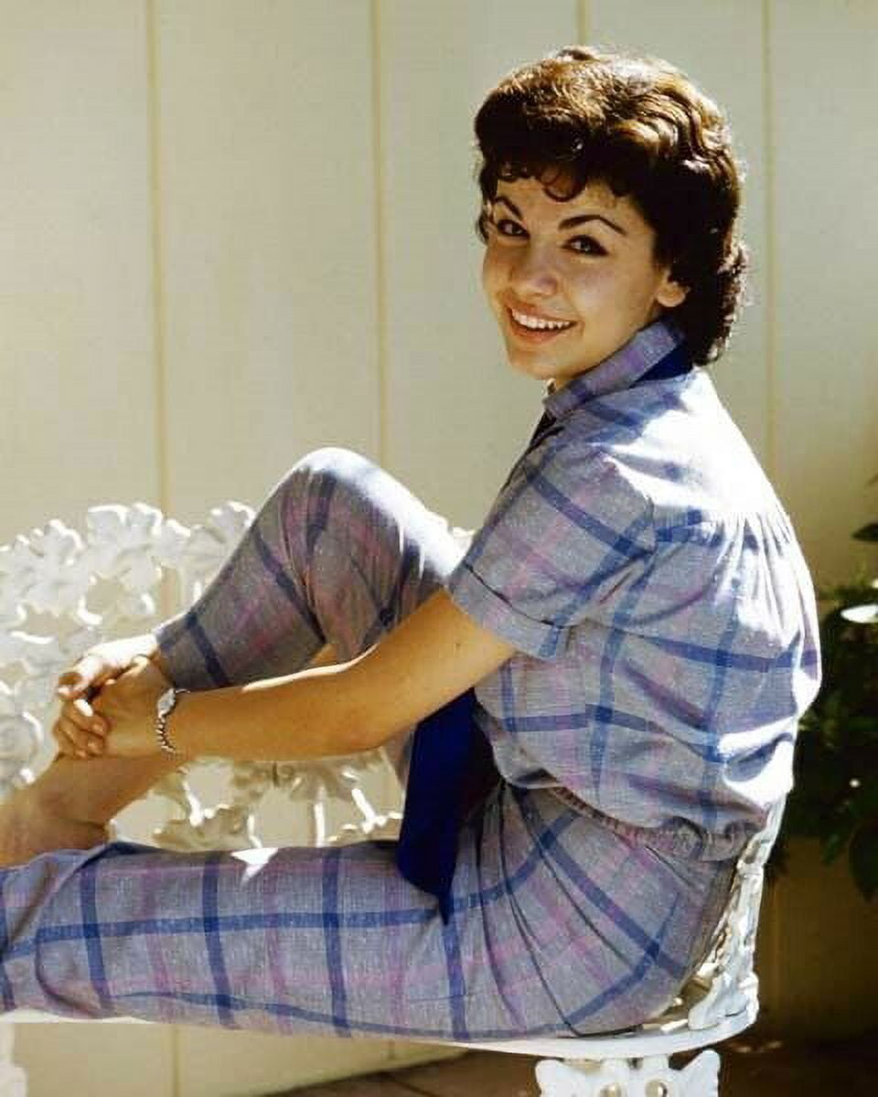 Annette Funicello pretty pose in one-piece out fit sitting on chair ...