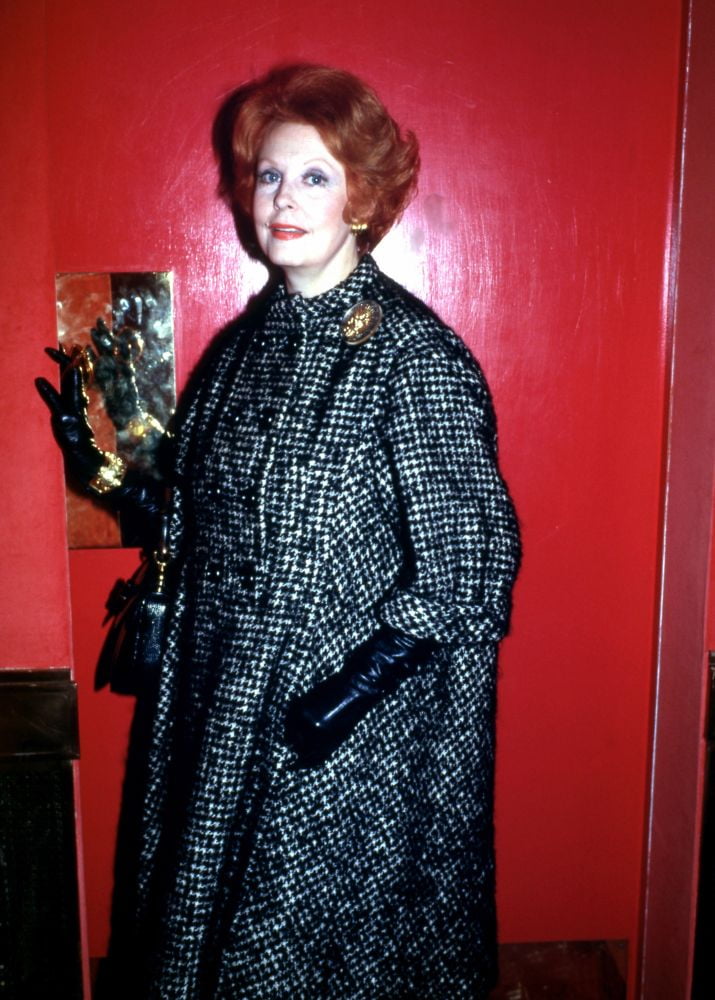 Arlene Dahl full standing shot wearing a black and white coat and black ...