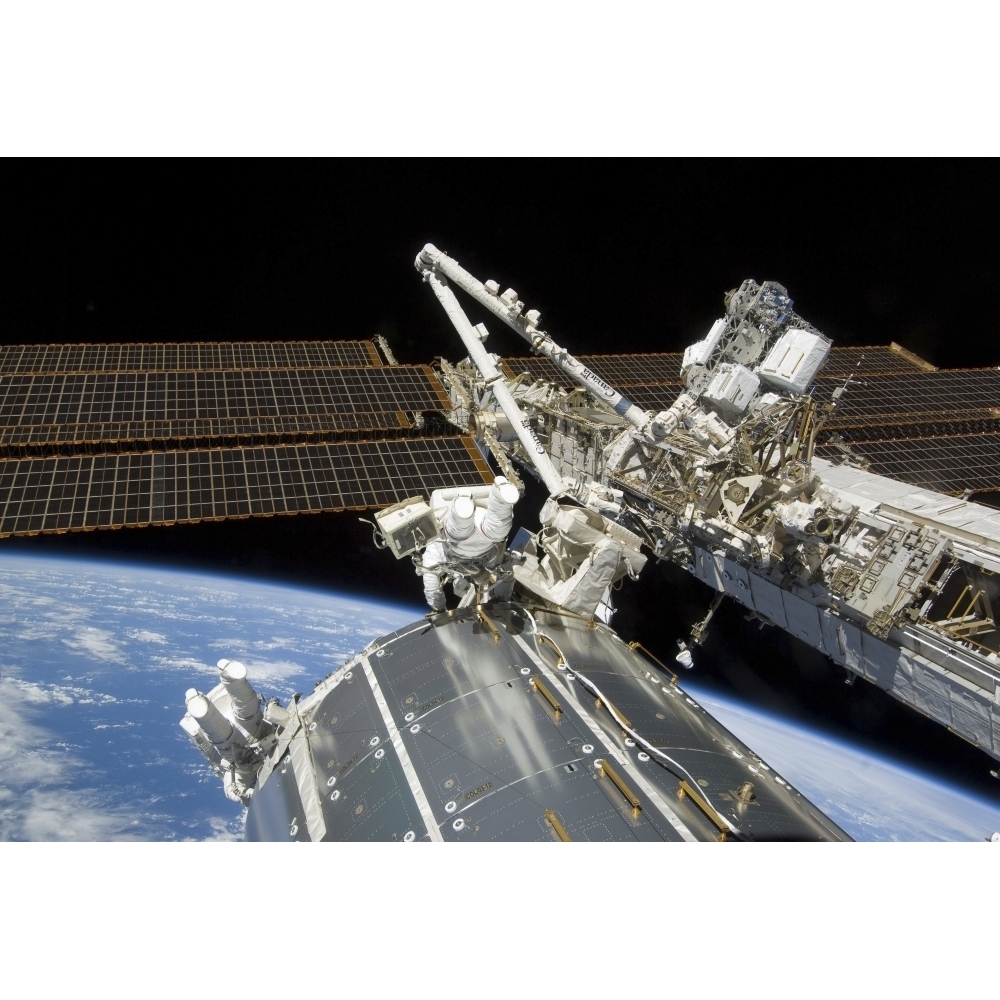 Astronauts perform a series of tasks on the exterior of the ...