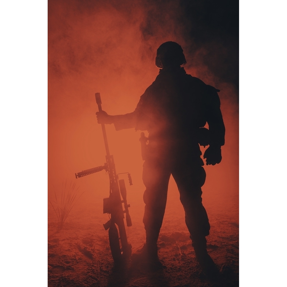 Backlit silhouette of Army sniper with large caliber rifle standing in ...