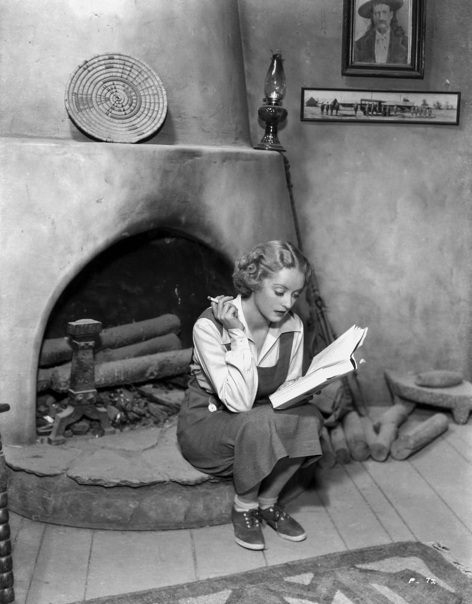 Bette Davis Seated Near the Fireplace with Cigarette on Hand while ...